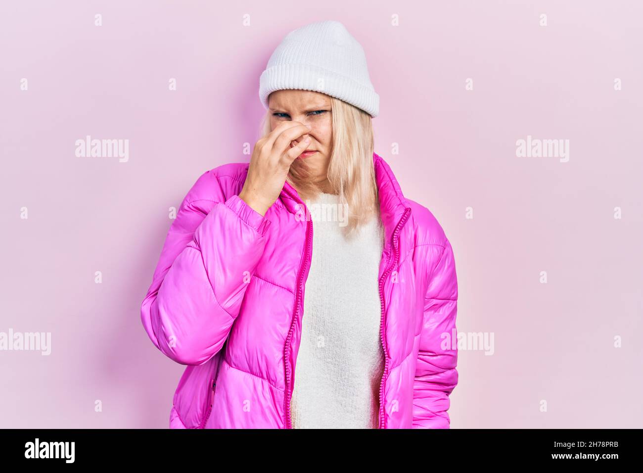 Beautiful caucasian blonde woman wearing wool hat and winter coat ...