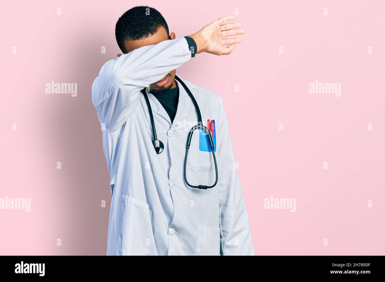 Young african american man wearing doctor uniform and stethoscope ...