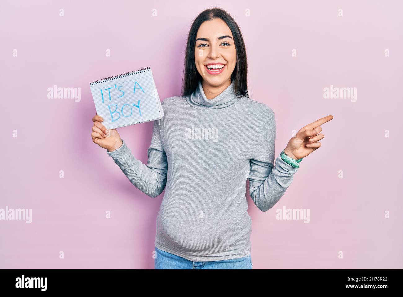 Beautiful woman with blue eyes expecting a baby holding its a boy ...