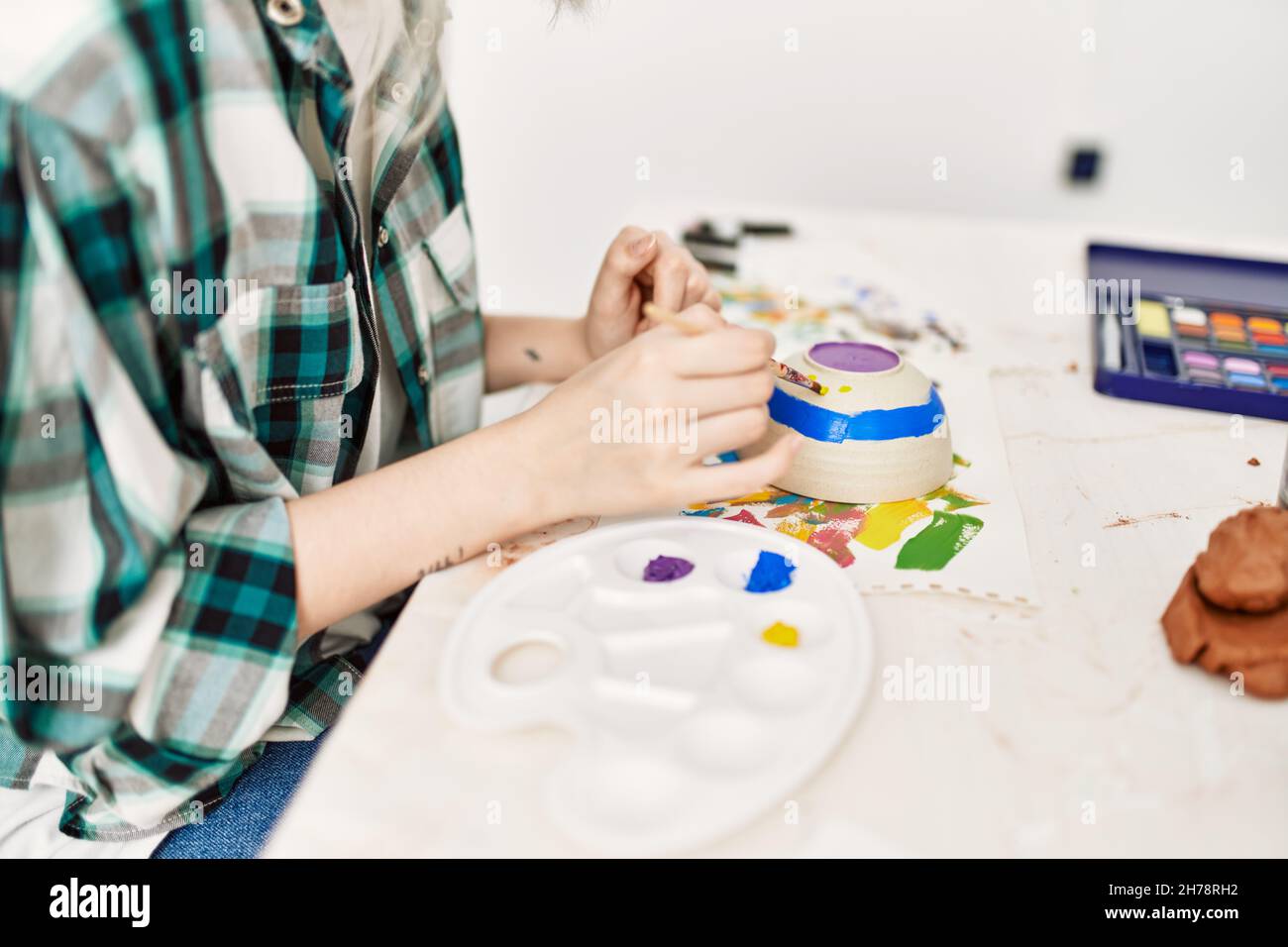 Artist student girl painting pottery at art studio Stock Photo - Alamy