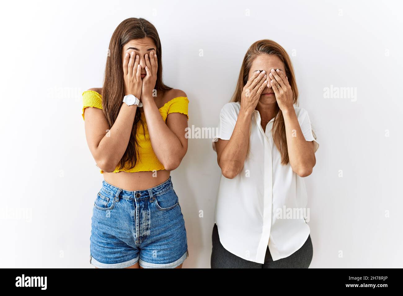 Mother and daughter together standing together over isolated background ...