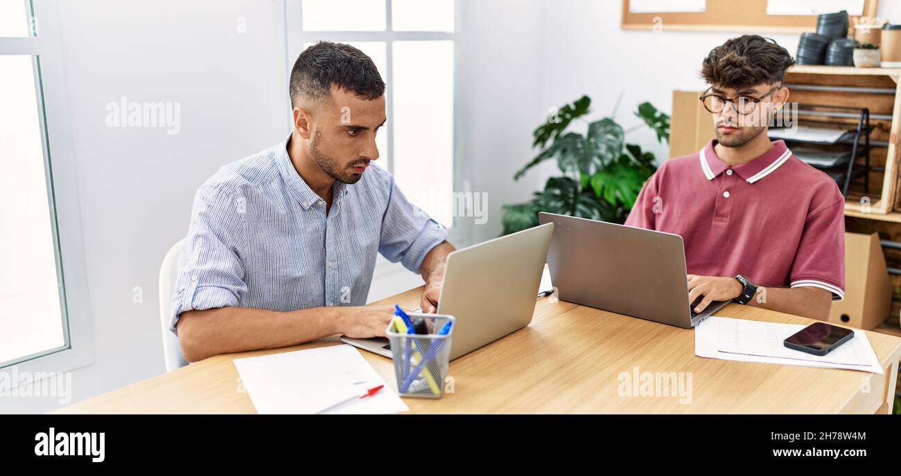 Two business workers smiling happy working at the office Stock Photo ...
