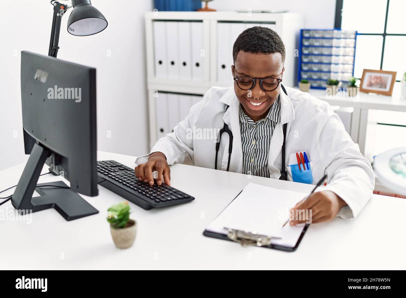 Young african man working as doctor at medical clinic Stock Photo - Alamy