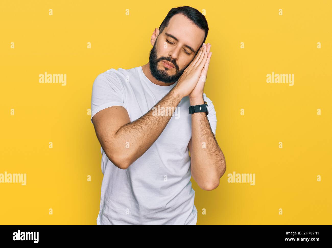 Young man with beard wearing casual white t shirt sleeping tired ...