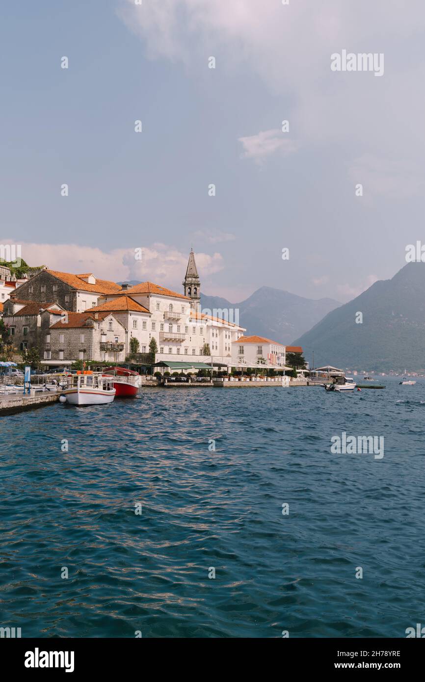 Perast buildings against the background of mountains in the haze ...