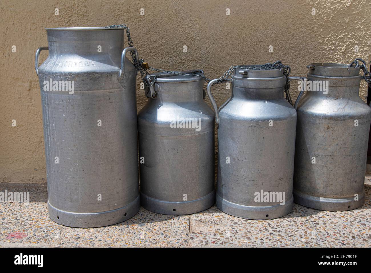 antique milk churns different sizes and colors Stock Photo - Alamy