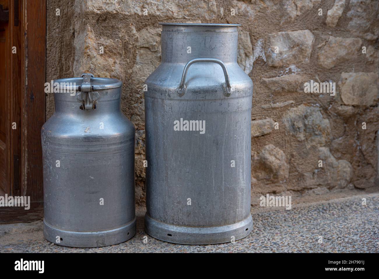 antique milk churns different sizes and colors Stock Photo - Alamy