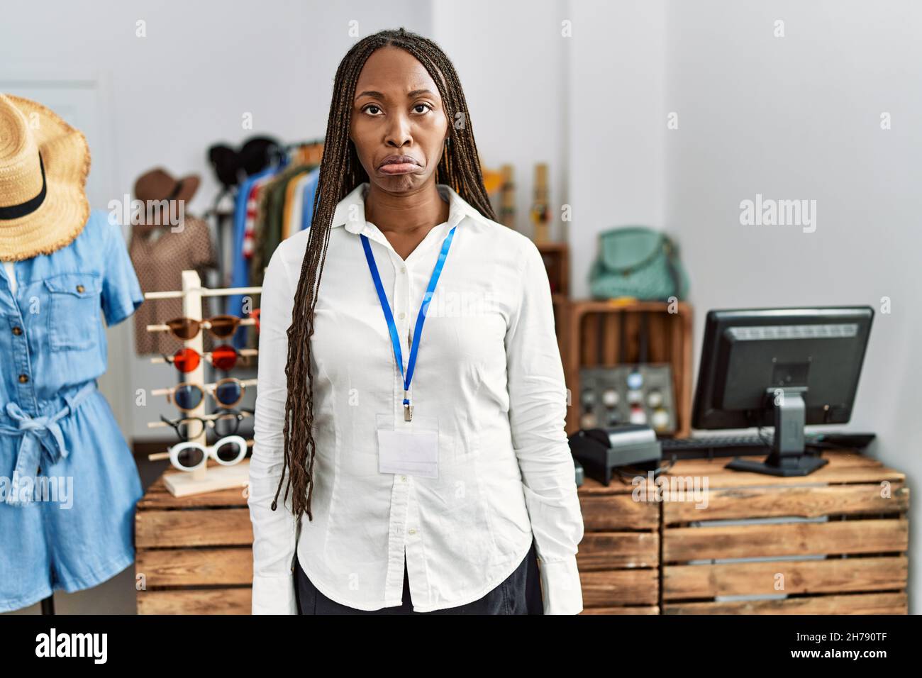 Black woman with braids working as manager at retail boutique depressed ...