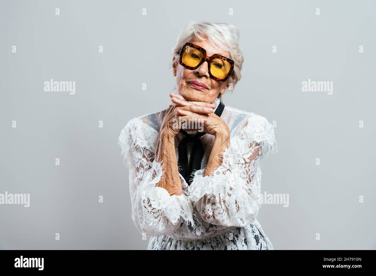 beautiful and elegant old influencer woman. Cool grandmother posing in ...