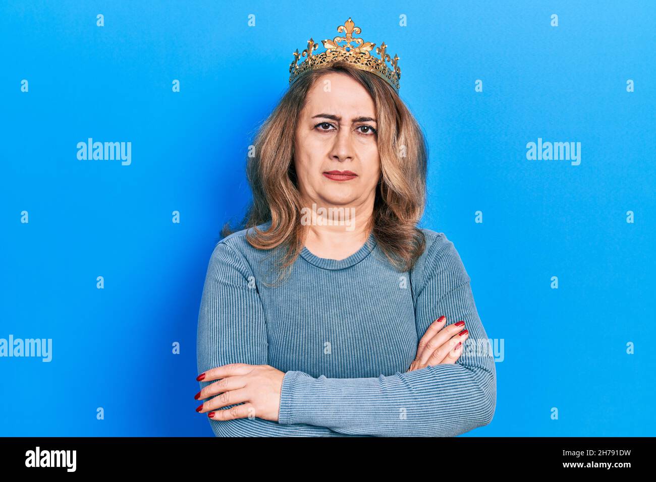 Middle age caucasian woman wearing queen crown skeptic and nervous ...