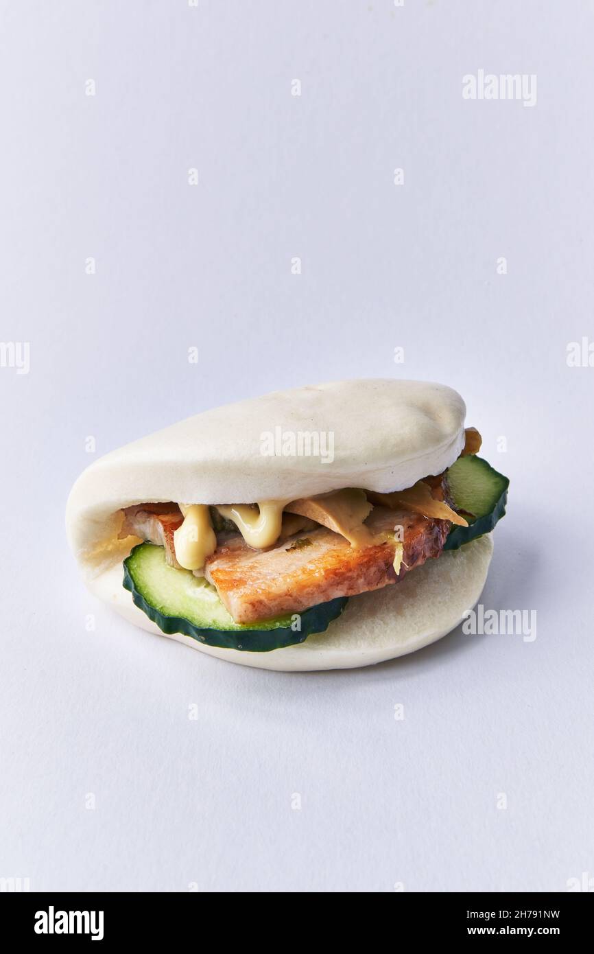 Single bao bun isolated on a white background Stock Photo - Alamy