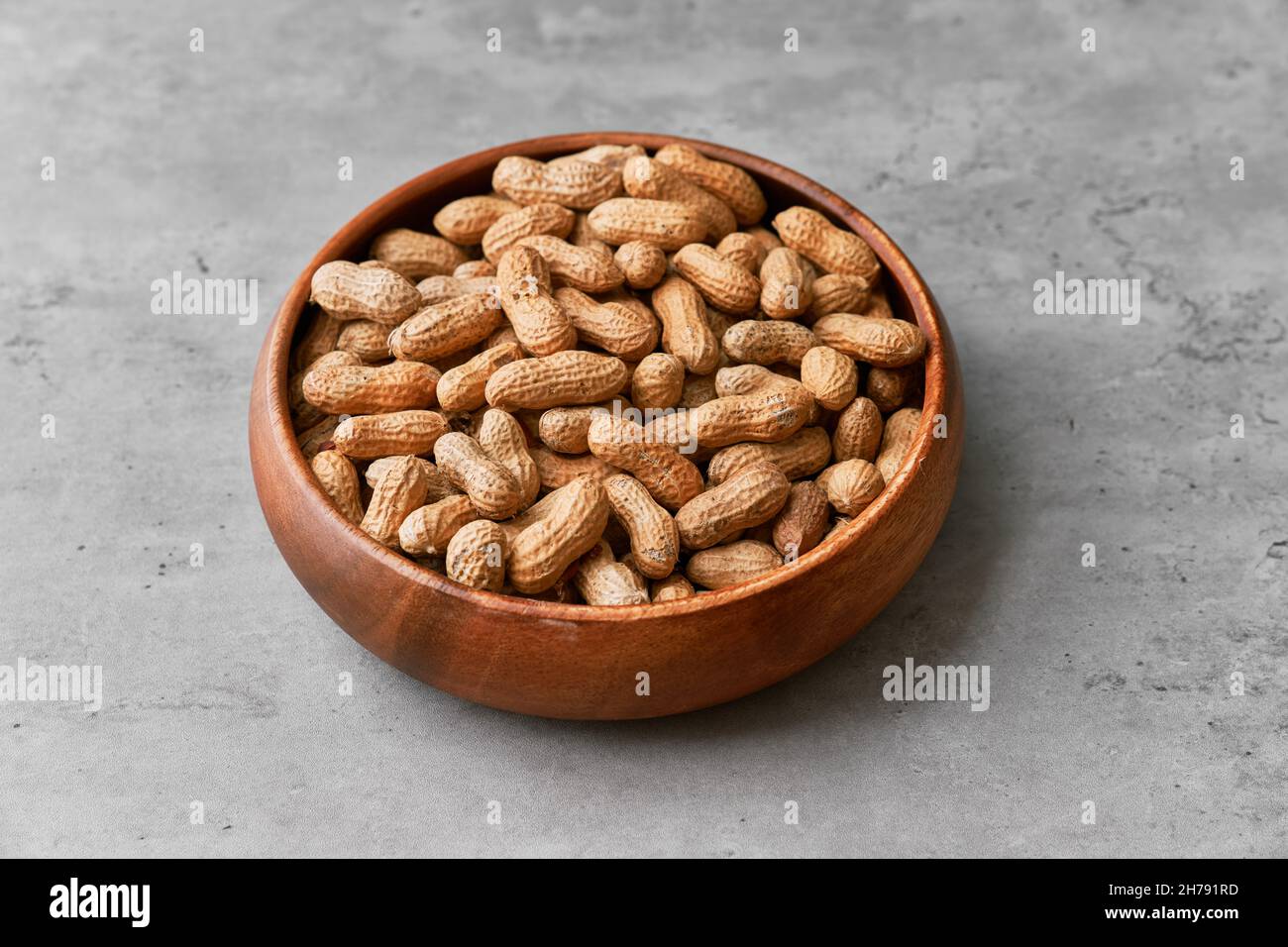 Image of bunch of peanuts in a bowl on a concrete surface Stock Photo ...