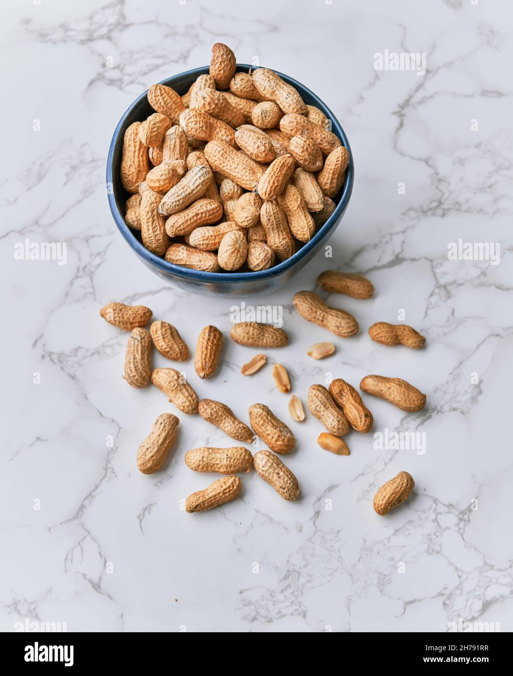 Image of bunch of peanuts in a bowl on a marble table Stock Photo - Alamy