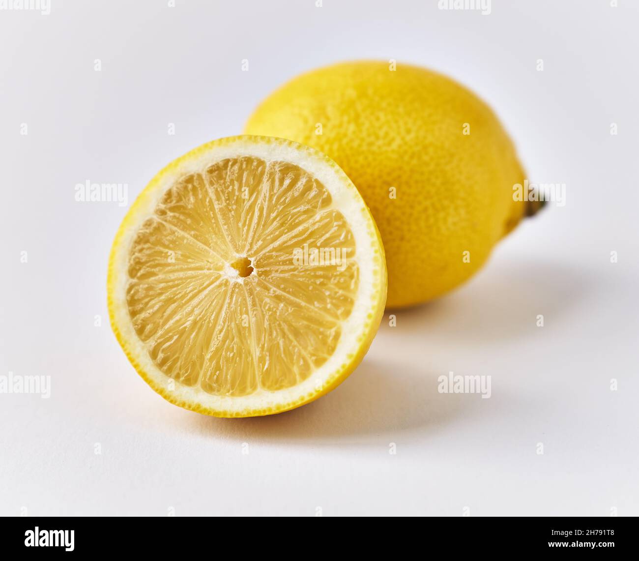 Single and half lemon fruit isolated on a white background Stock Photo ...