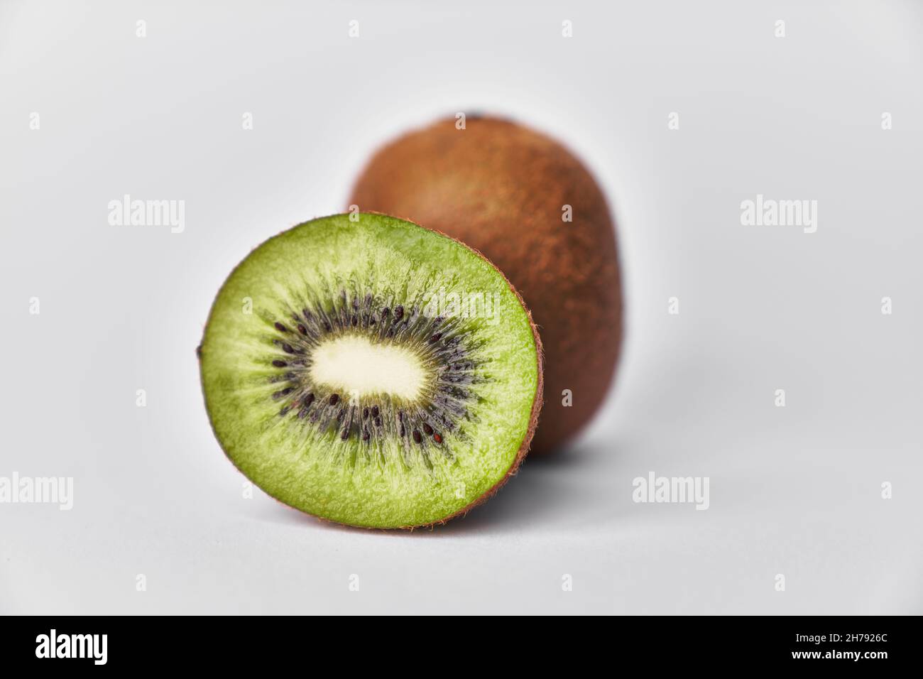 Single kiwi and slice isolated on a white background Stock Photo - Alamy