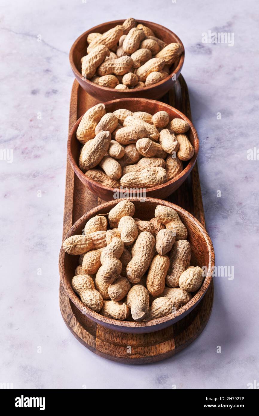 Bowls of peanuts with shell on a marble surface Stock Photo - Alamy