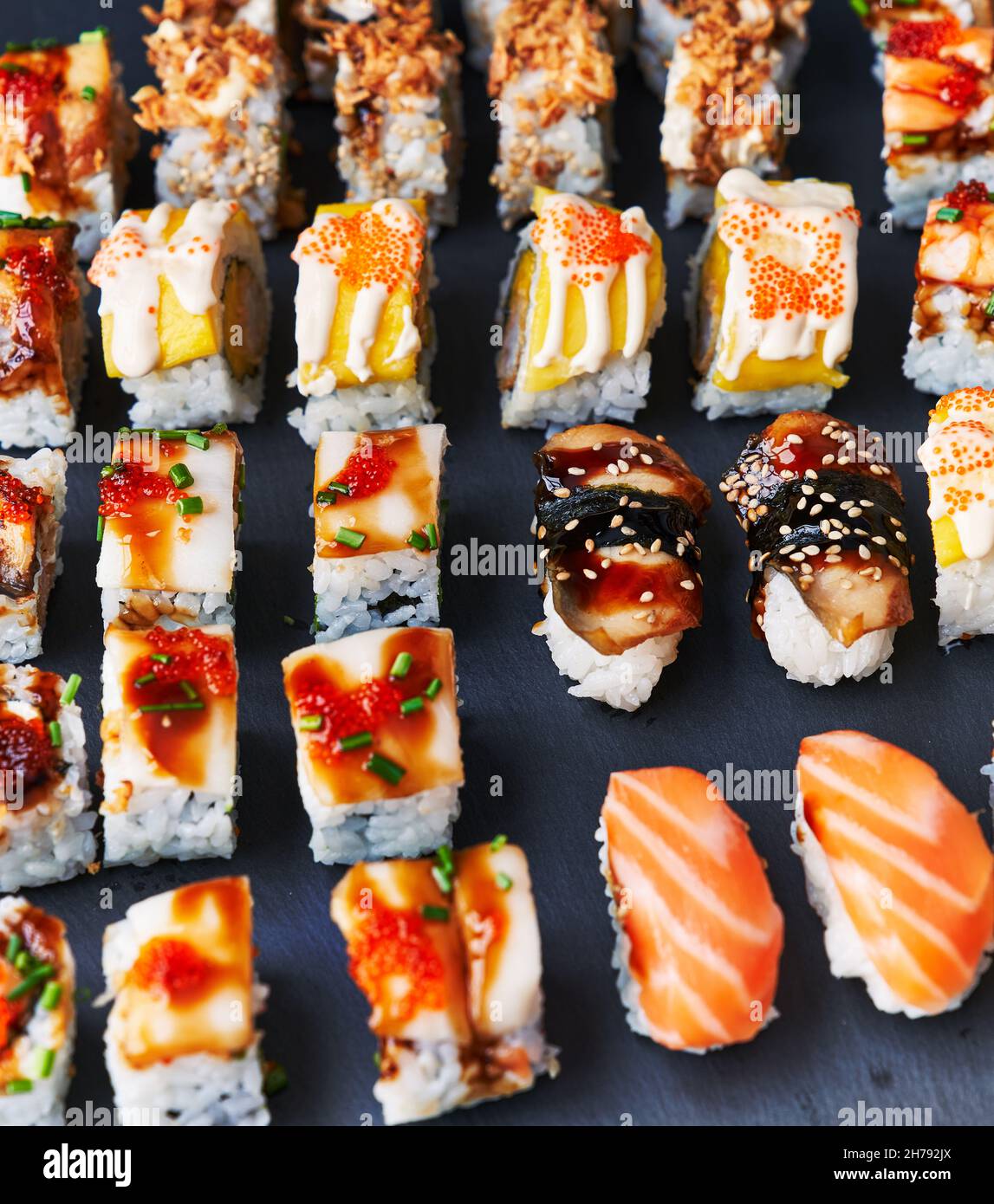 Group of sushi food rolls on a blackboard surface Stock Photo - Alamy