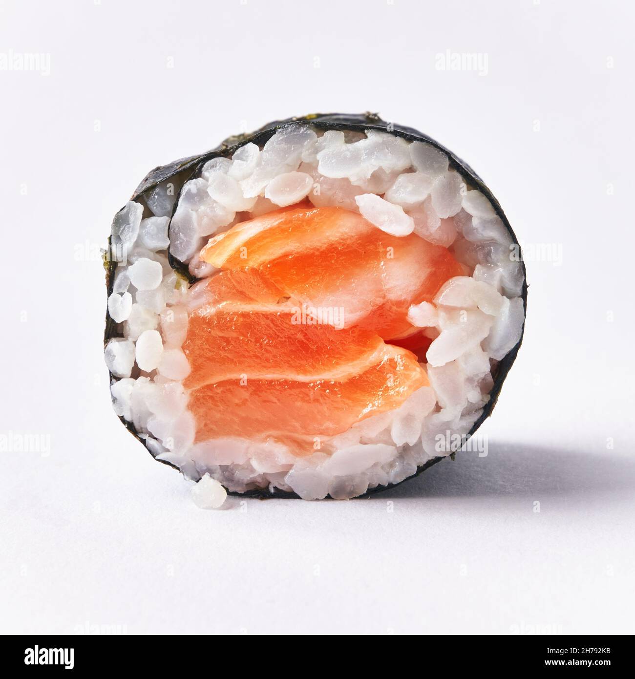 Single salmon sushi maki isolated on white background Stock Photo - Alamy