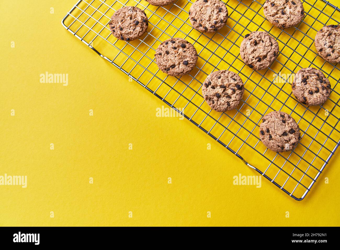 Chocolate cookies served on a grid rack on a yellow background Stock ...
