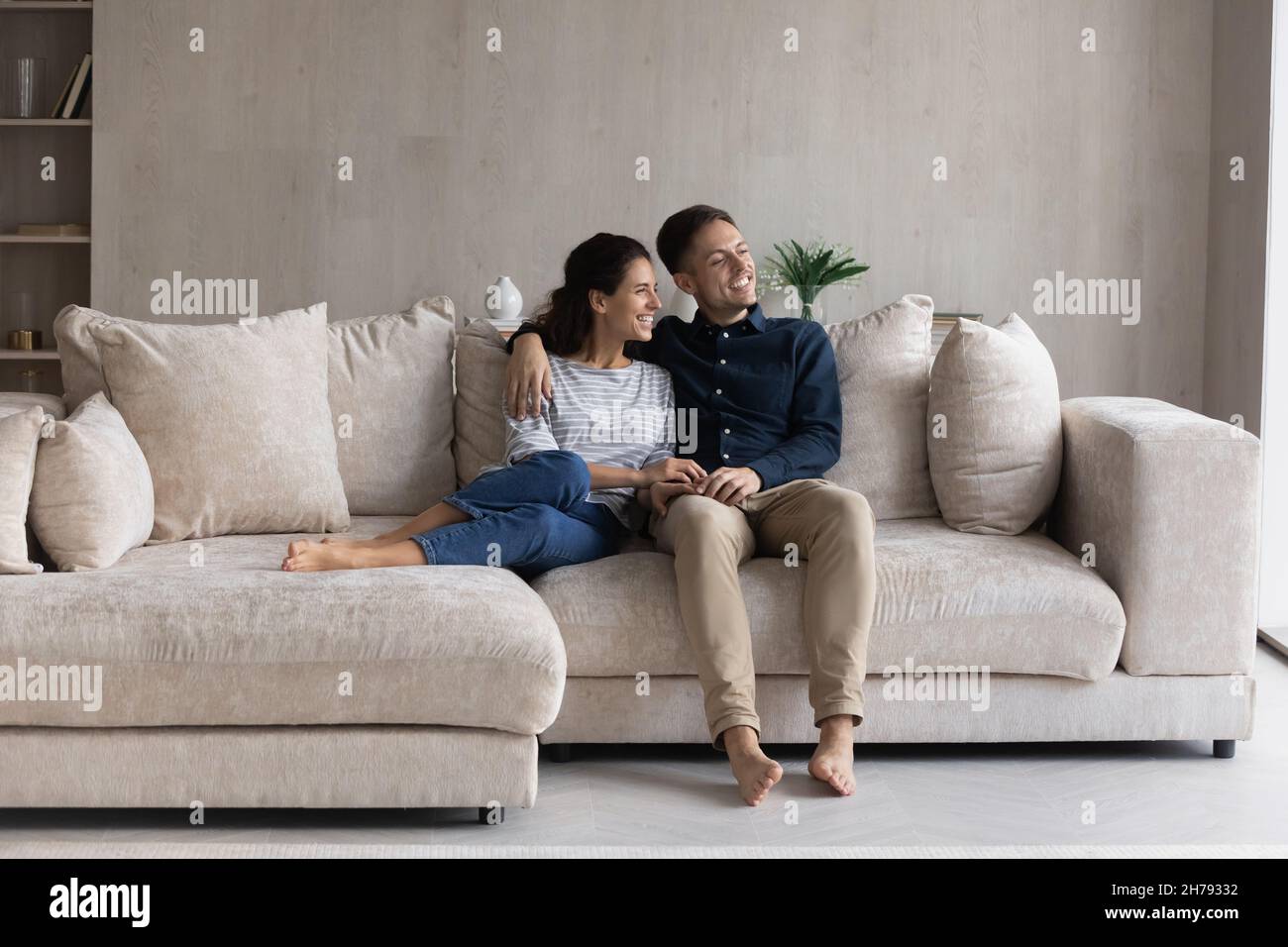 Peaceful couple relaxing on comfortable couch looking out window Stock ...