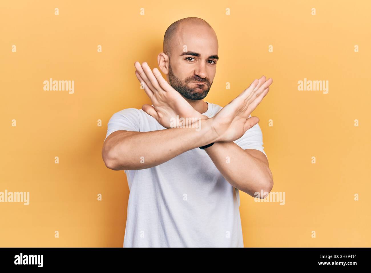 Young bald man wearing casual white t shirt rejection expression ...