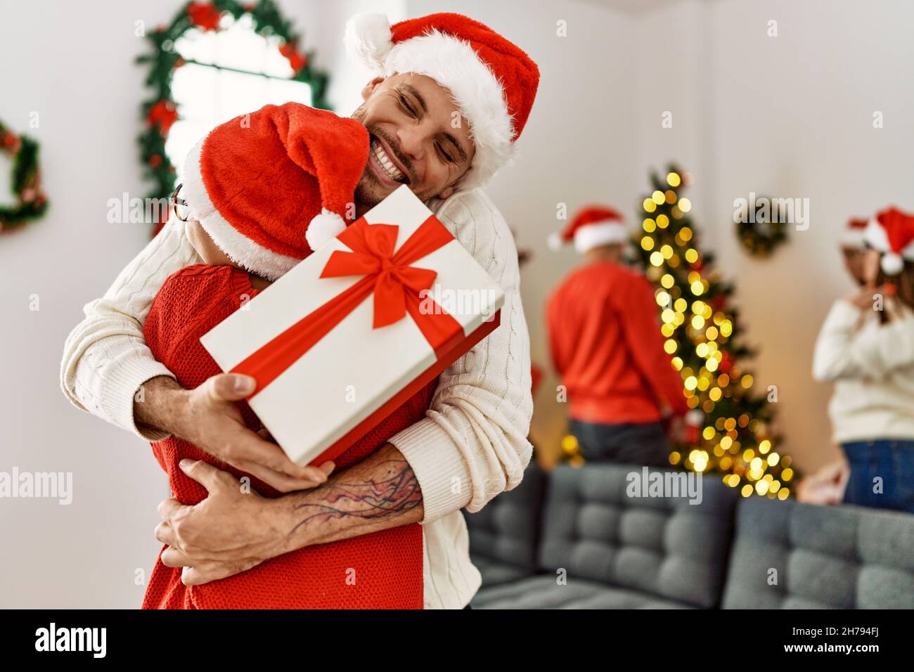 Group of young people on christmas meeting. Couple holding gift and ...