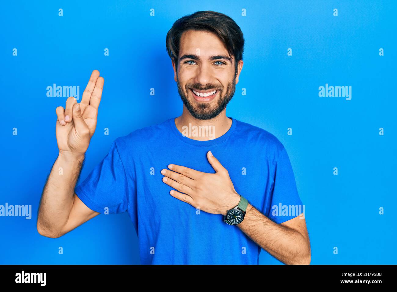 Young Hispanic Man Wearing Casual Clothes Smiling Swearing With Hand On
