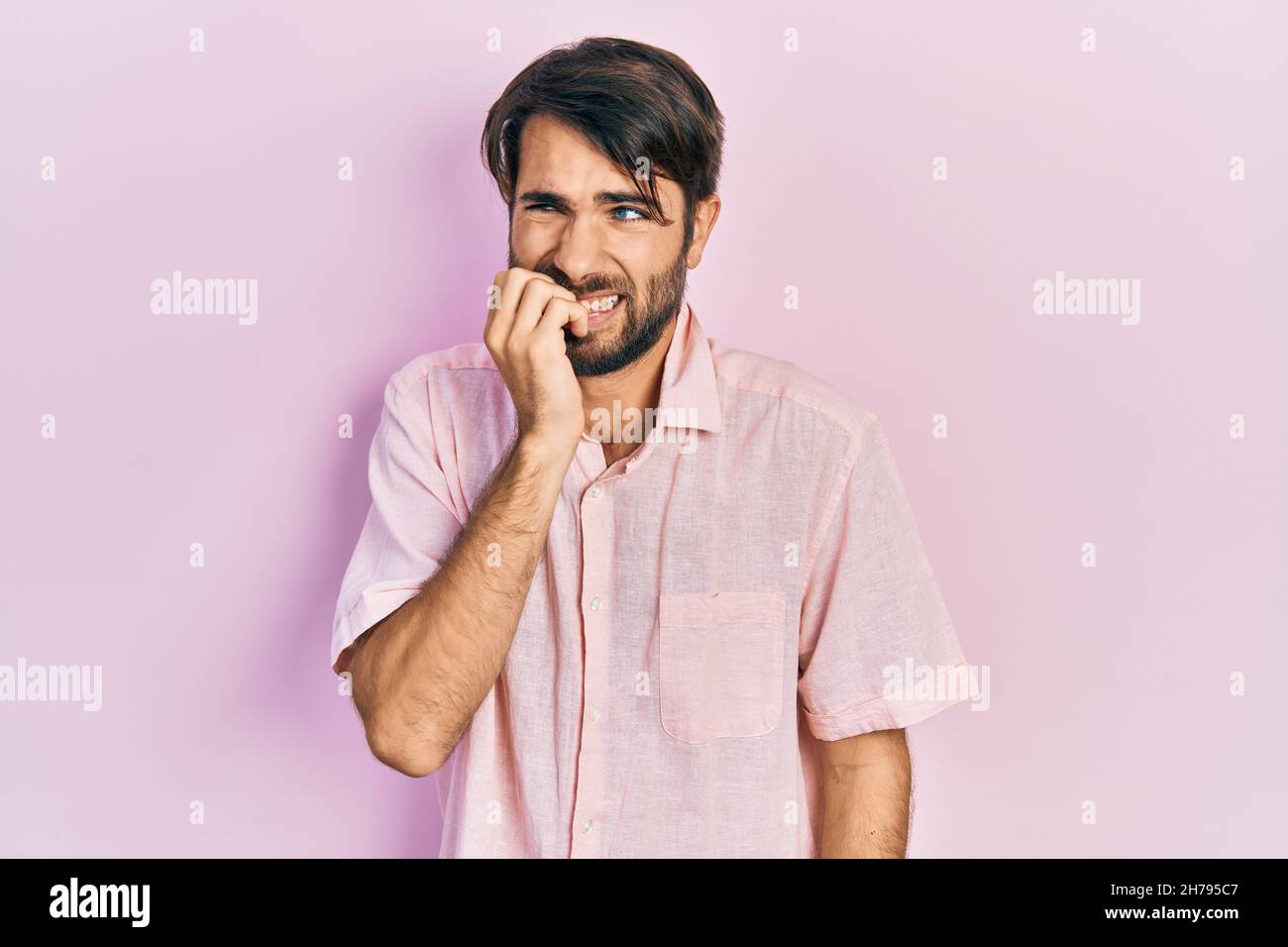 Young hispanic man wearing casual clothes looking stressed and nervous ...
