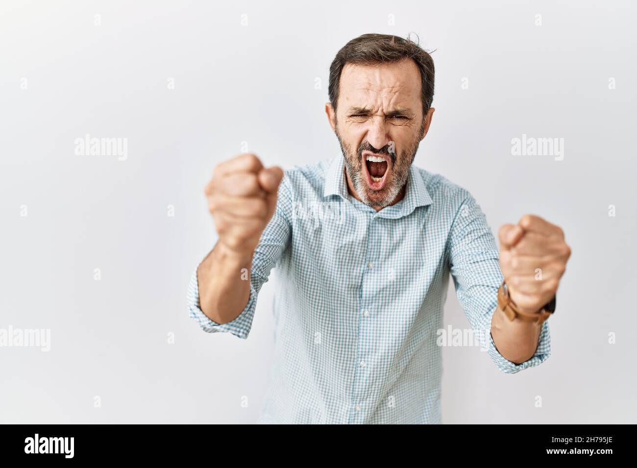 Middle age hispanic man with beard standing over isolated background ...