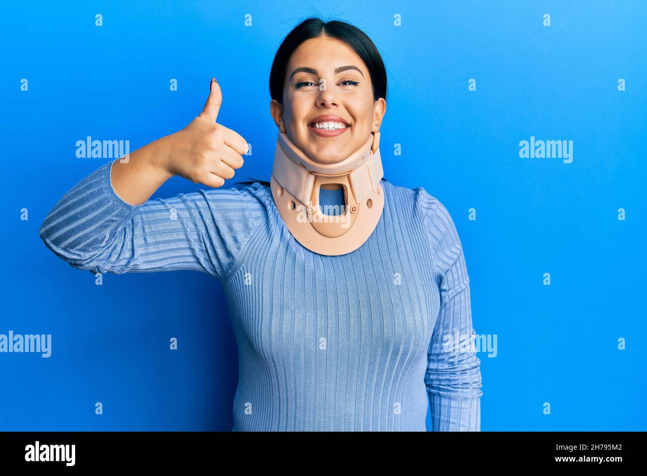 Beautiful brunette woman wearing cervical collar smiling happy and ...