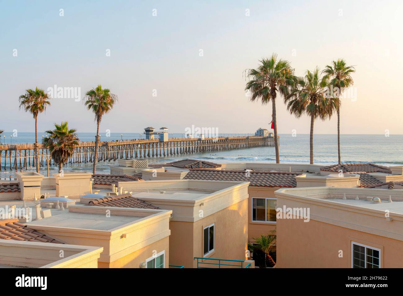 View of the pier and palm trees on the beach of Oceanside, California ...