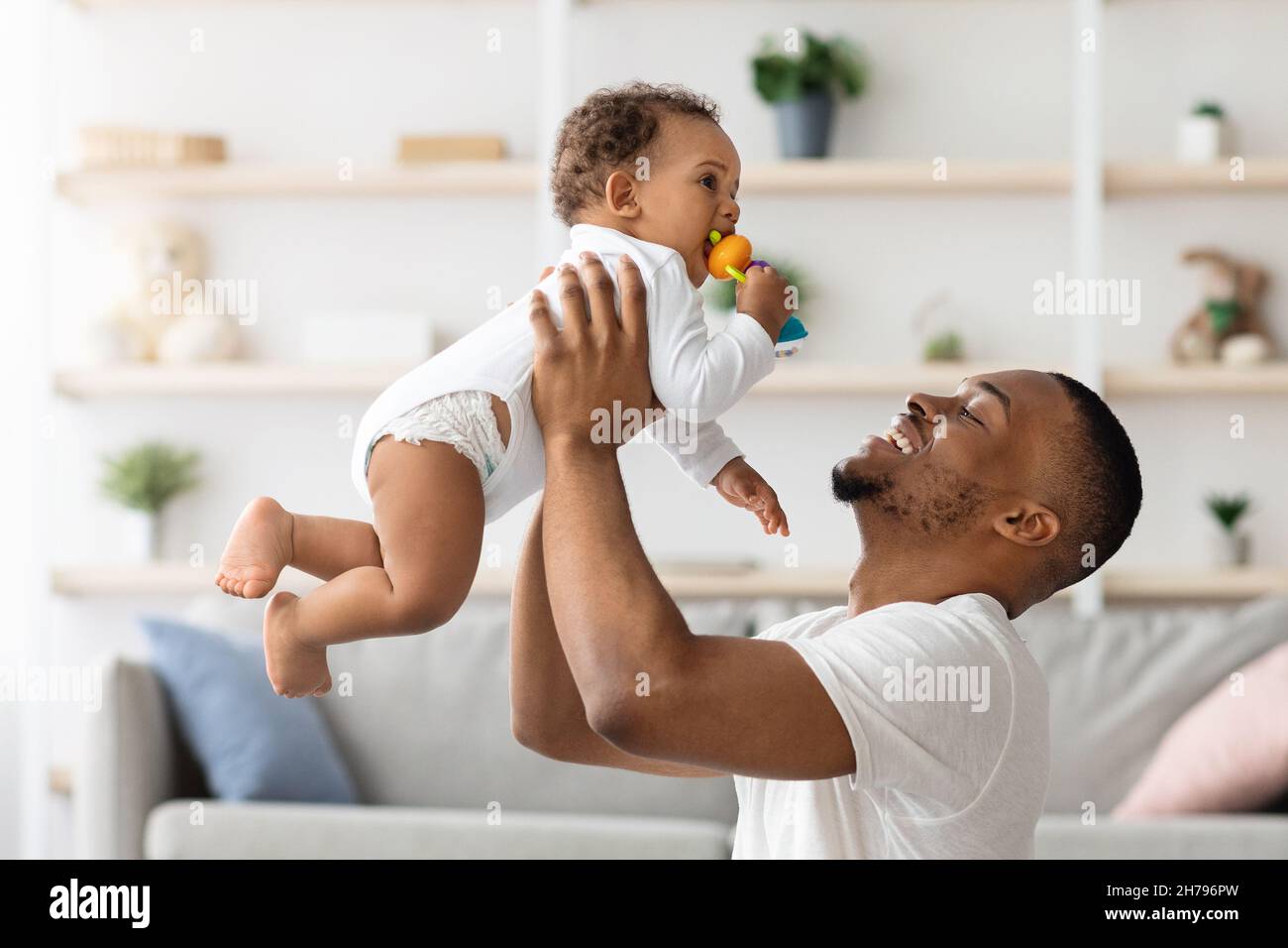 Father Baby Relationship. Happy Black Man Lifting Up His Adorable ...