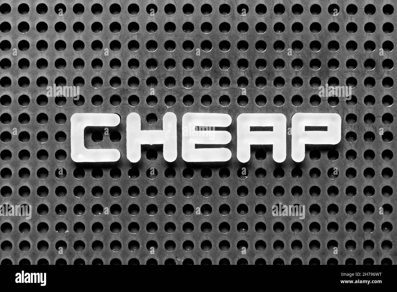 White alphabet letter in word cheap on black pegboard background Stock ...