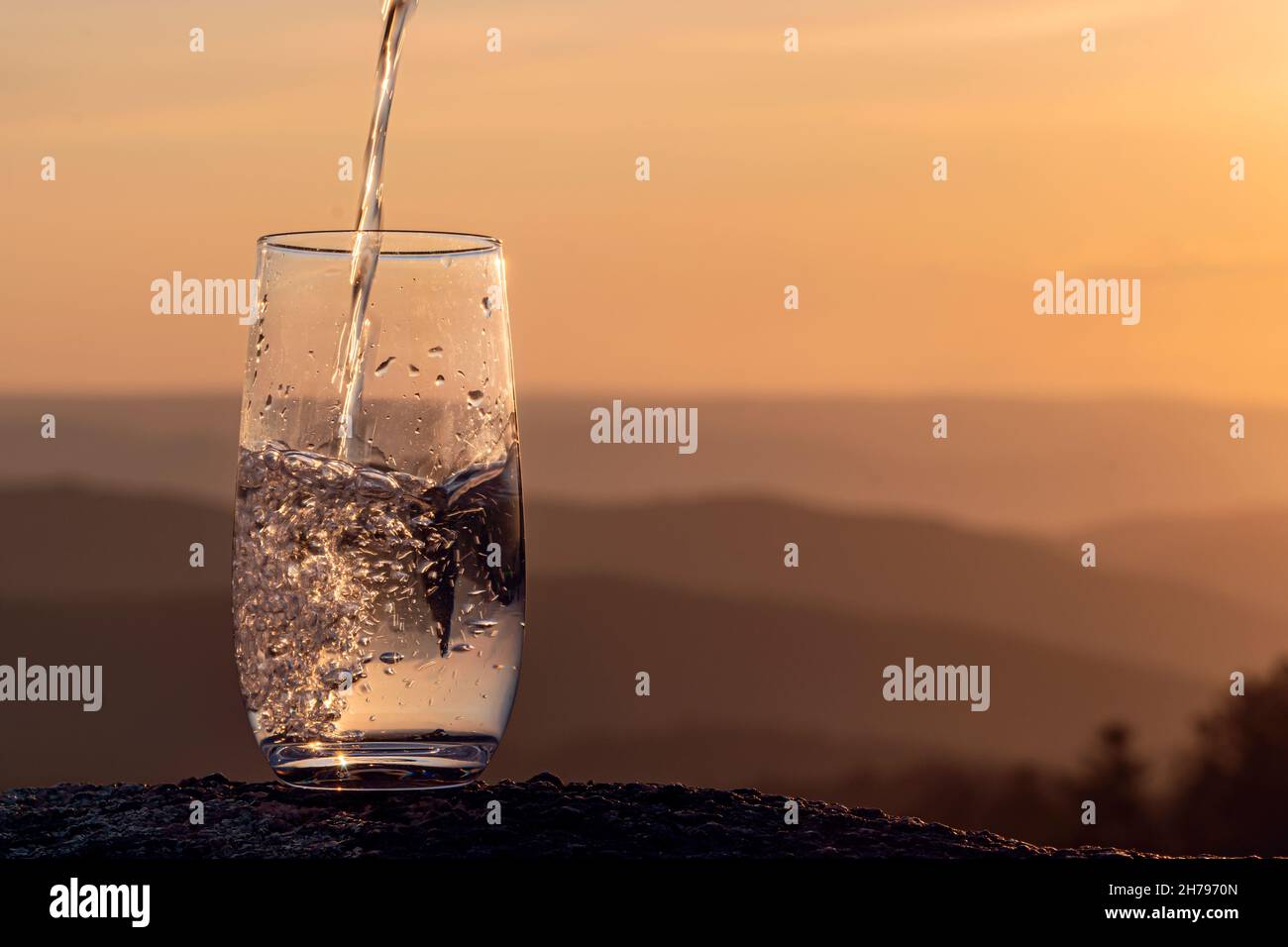a glass of pure transparent mineral drinking water against the ...