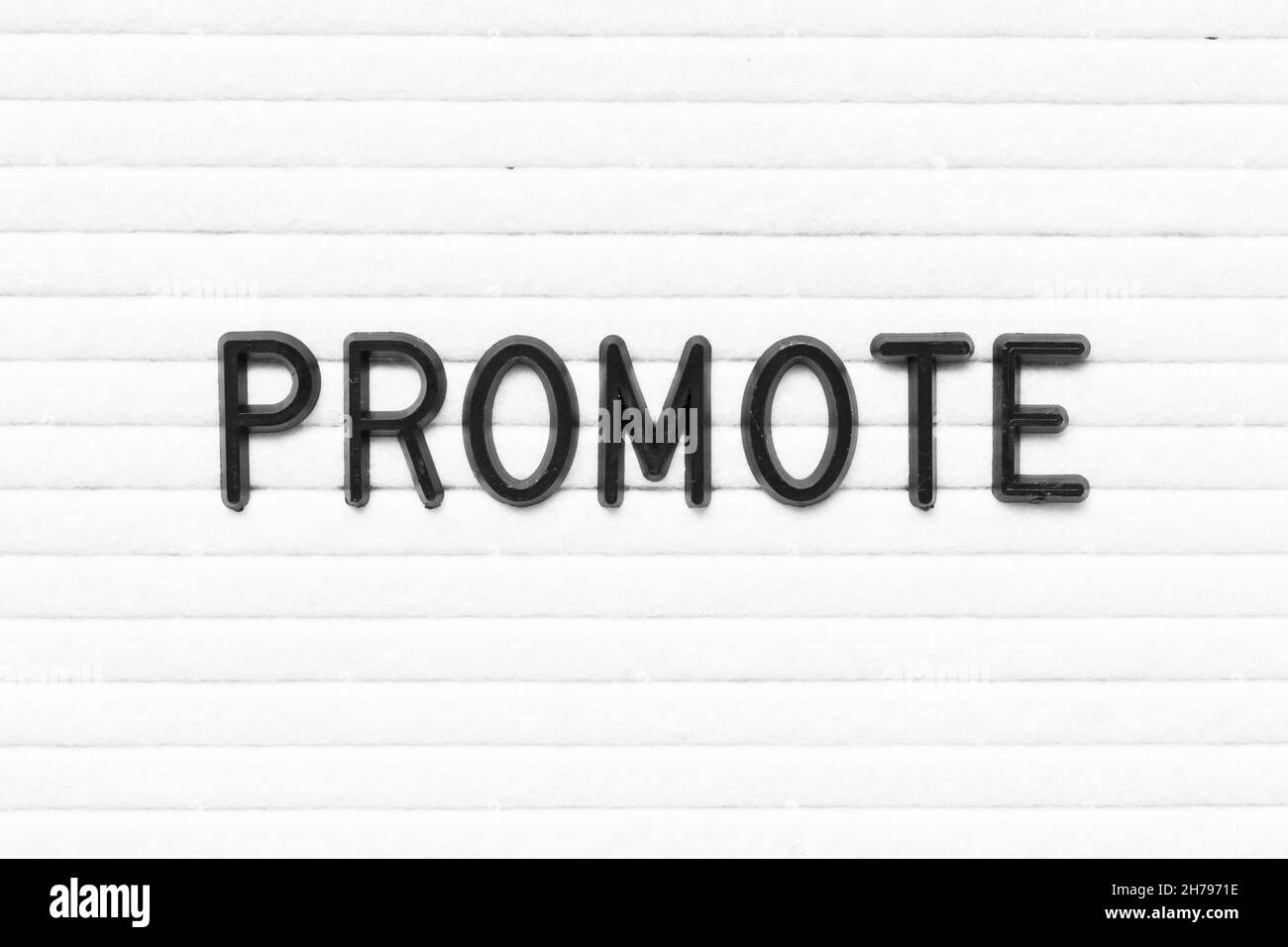 Black letter in word promote on white felt board background Stock Photo ...