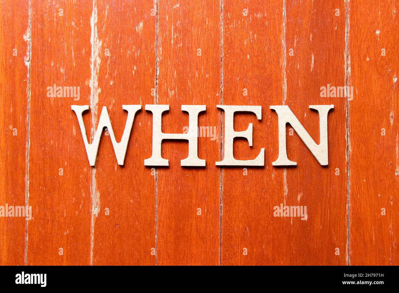Alphabet letter in word when on old red color wood plate background ...