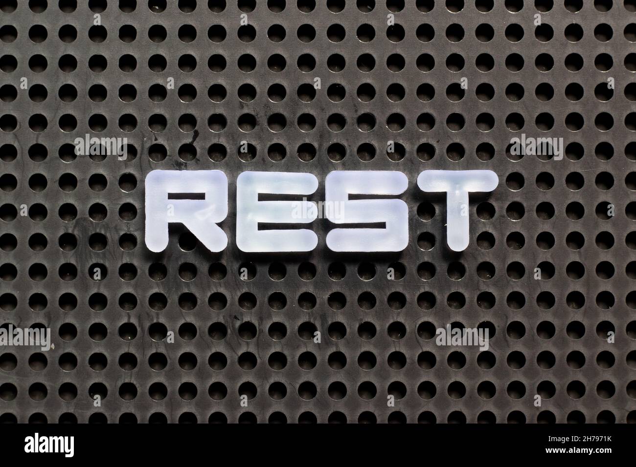 White color letter in word rest on black pegboard background Stock ...
