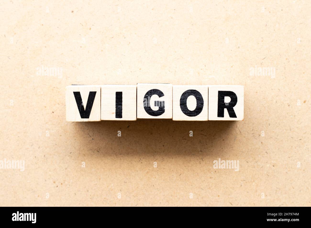 Letter block in word vigor on wood background Stock Photo - Alamy