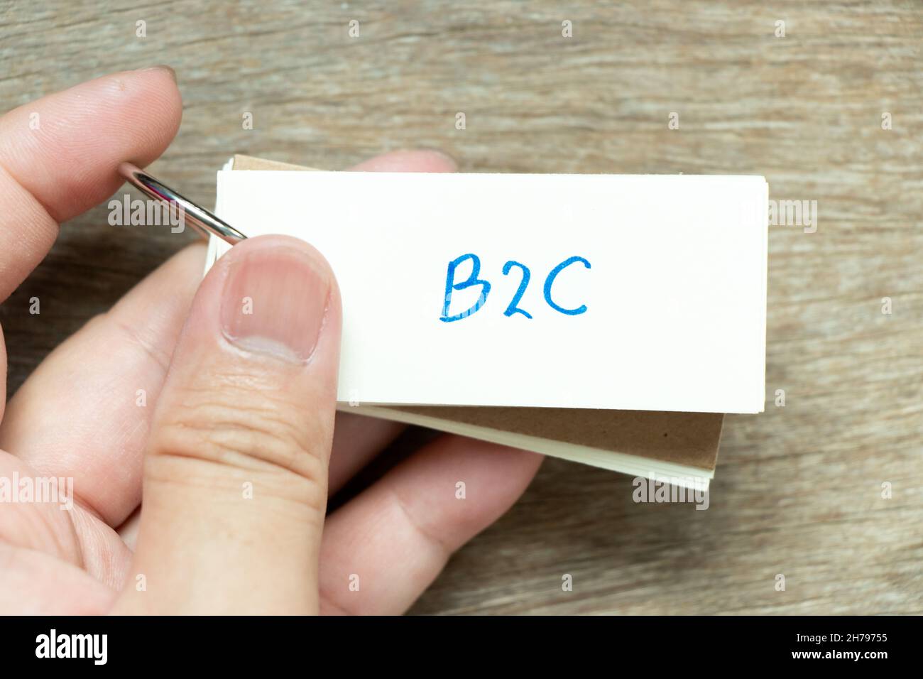 Man hold the flash card with handwriting word b2c (abbreviation of ...