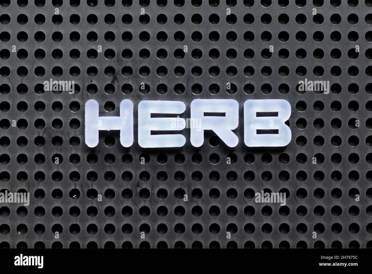 White color letter in word herb on black pegboard background Stock ...