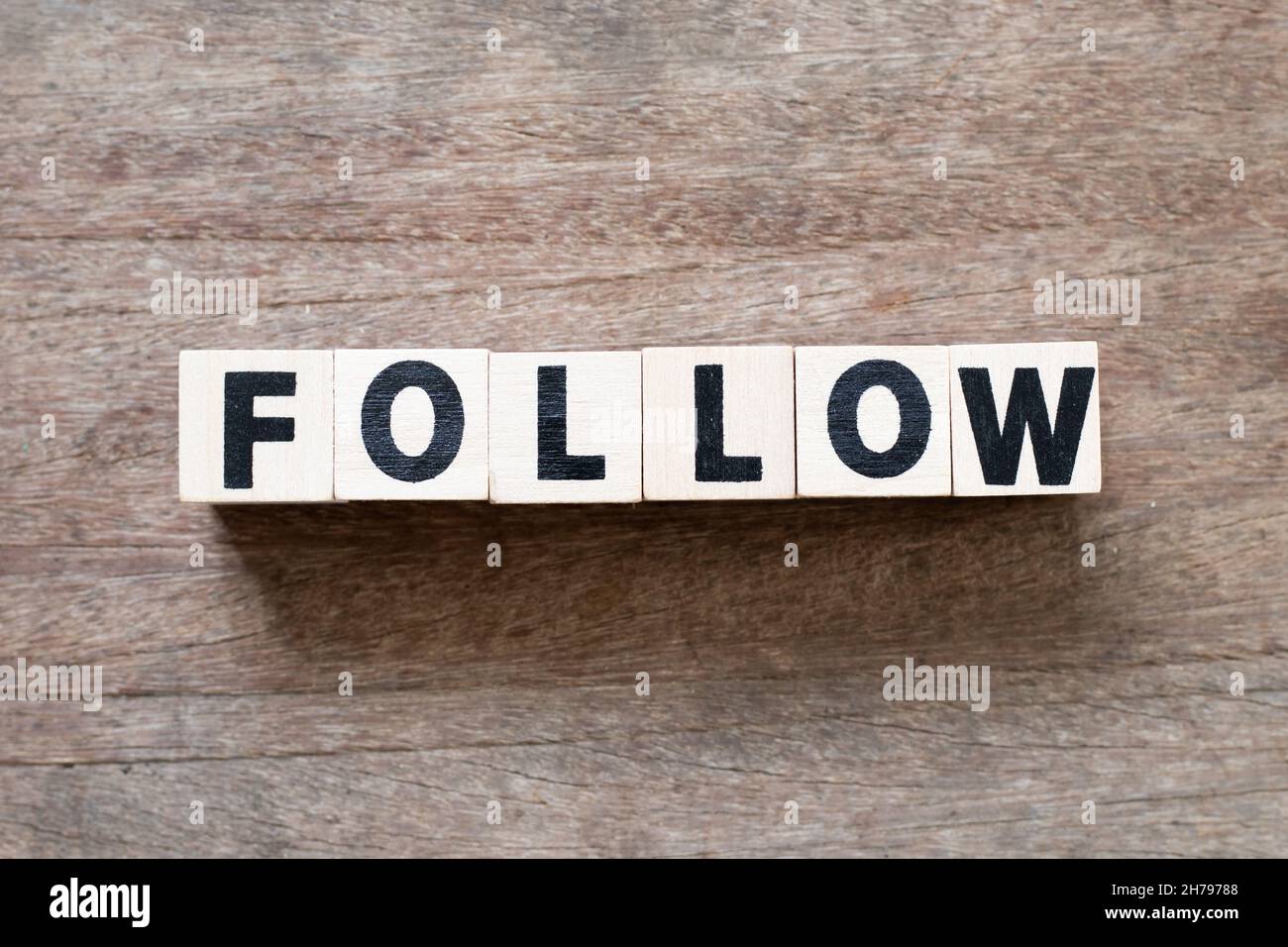 Alphabet letter block in word follow on wood background Stock Photo - Alamy