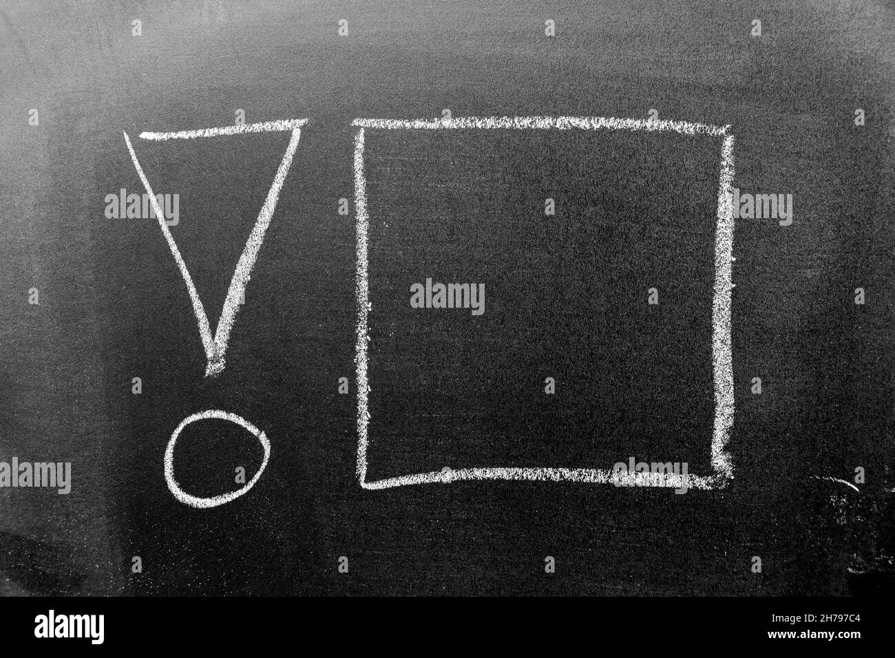 White color chalk hand drawing in exclamation mark and square shape on ...