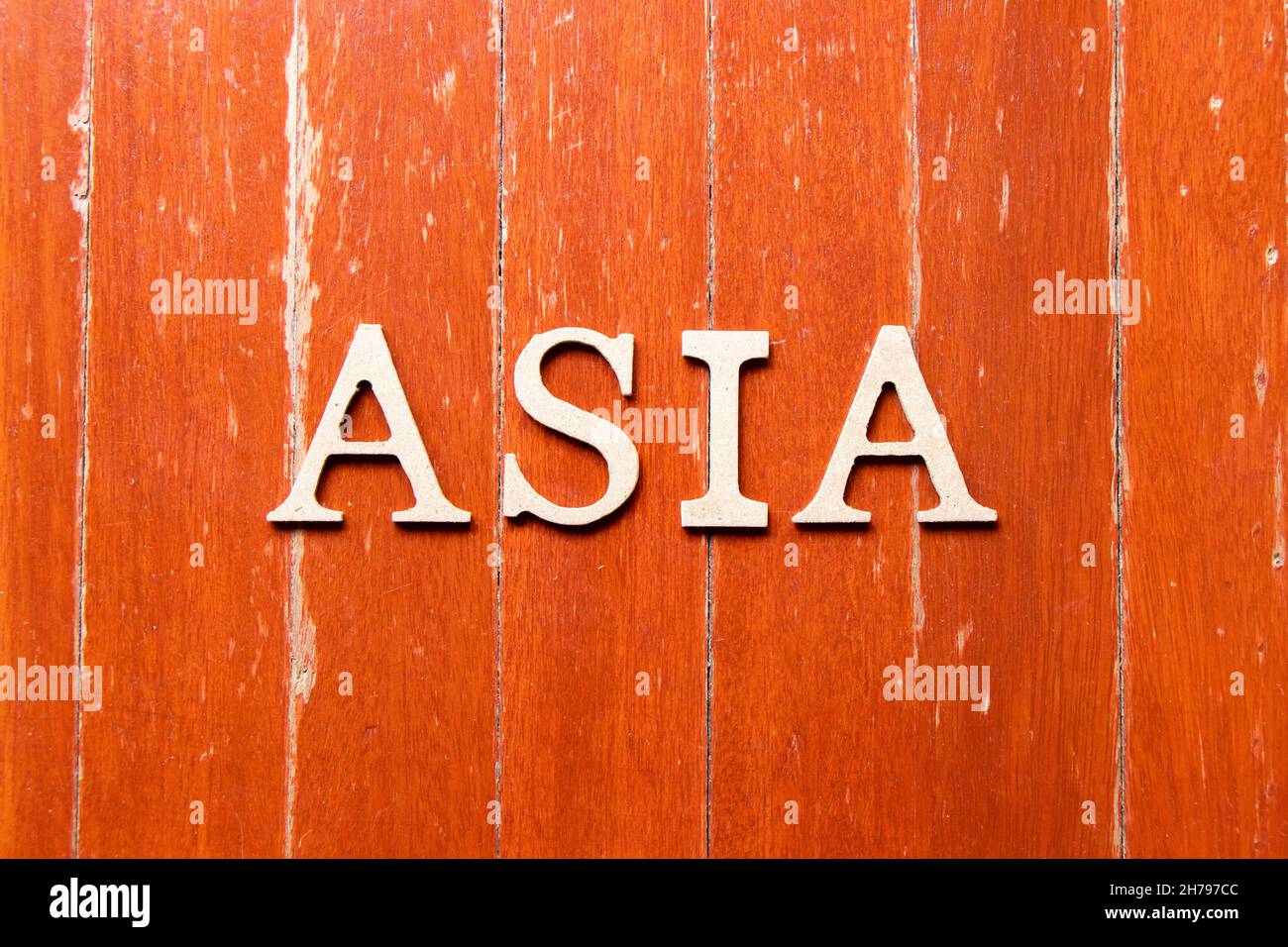 Alphabet letter in word asia on old red color wood plate background ...