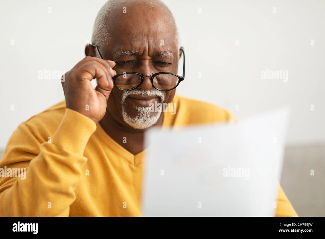 Senior African Man Squinting Eyes Reading Papers Wearing Eyeglasses ...