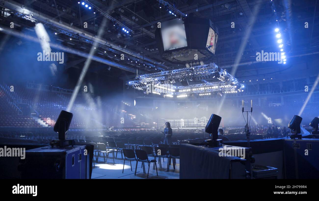 Strobe lights emitting different color beams hanging under the ceiling ...