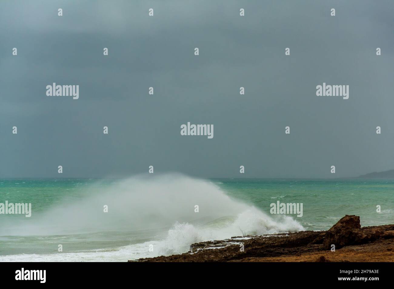 angry turquoise green color massive rip curl of a waves as it barrel ...