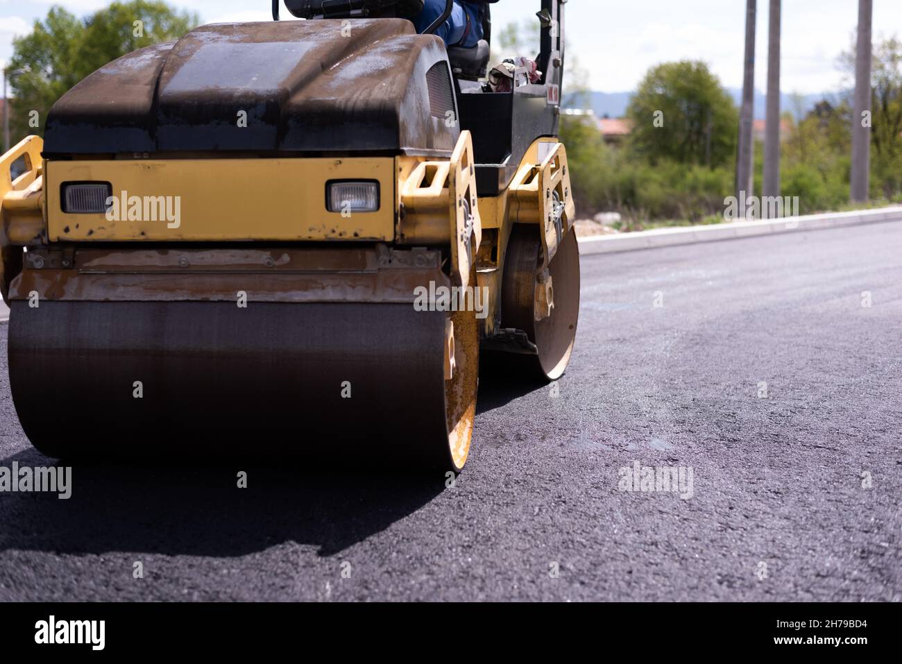 Urban road asphalting works. Asphalt paving. Paver machine and road ...