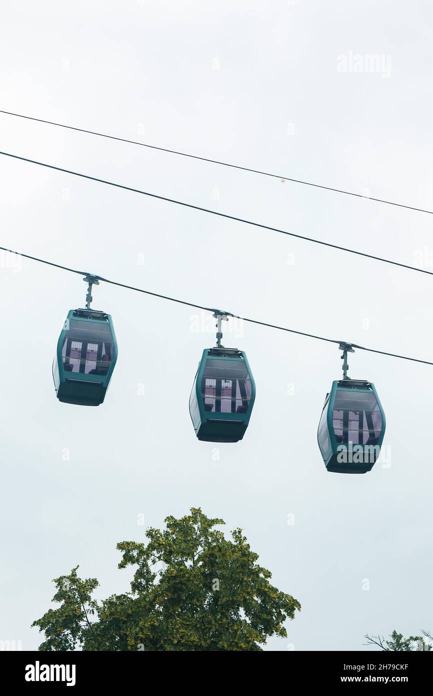 Three cable cars against cloudy sky in summer Stock Photo - Alamy