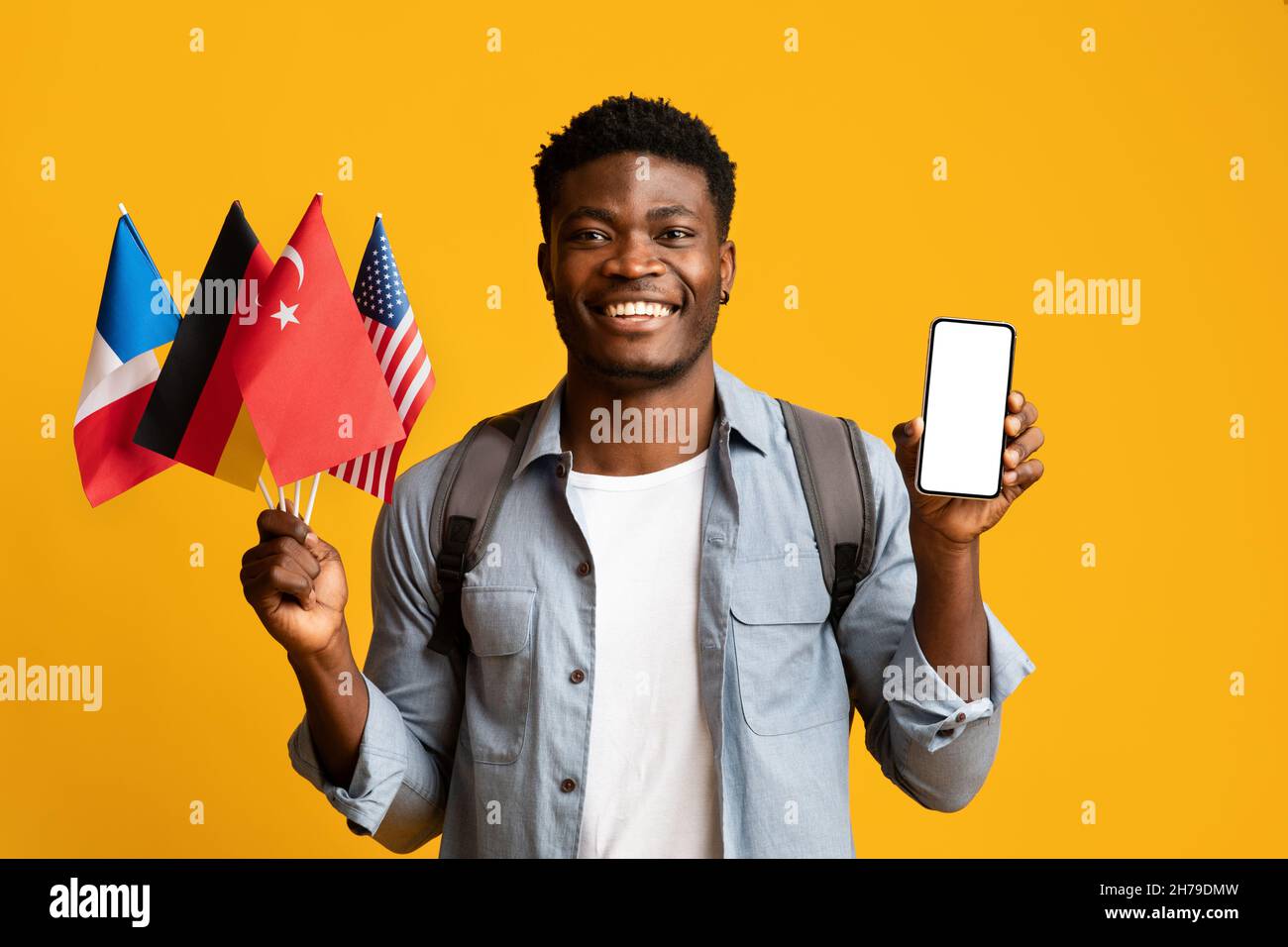 Happy black guy with flags and mobile phone, mockup Stock Photo - Alamy