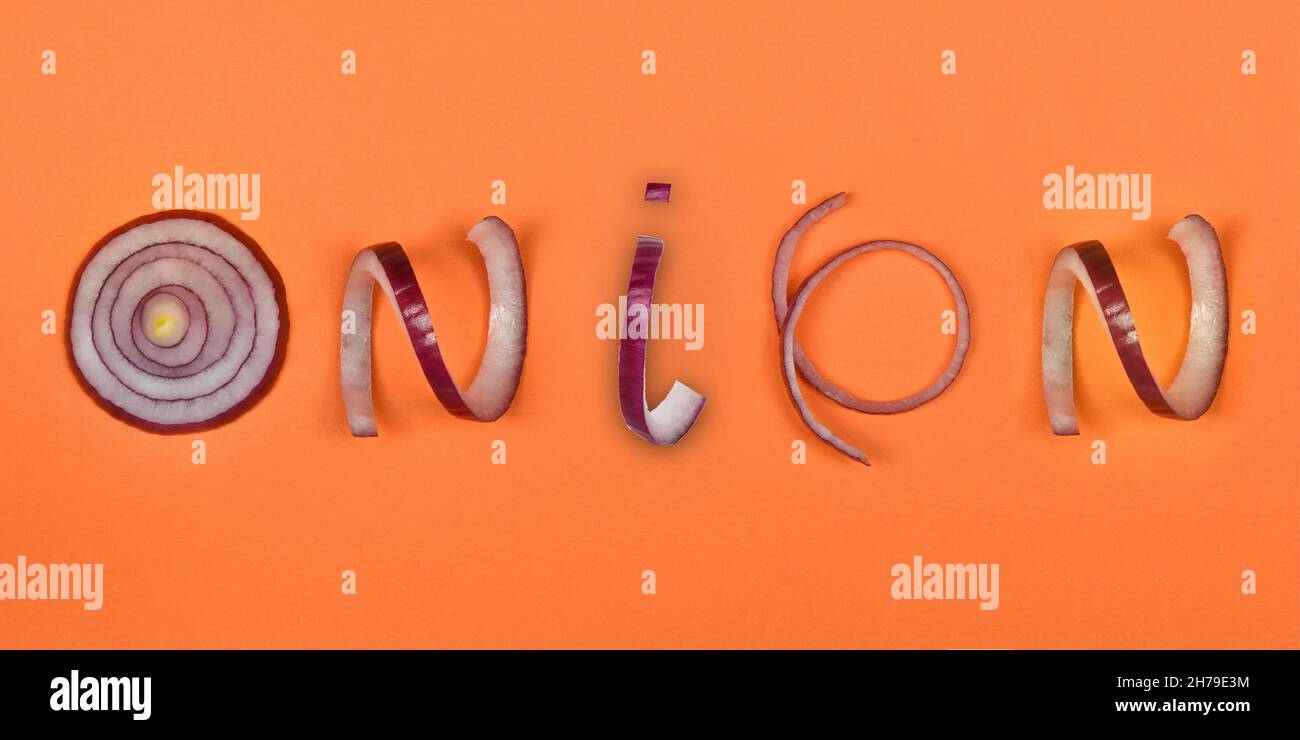 Onion inscription written in sliced red onions isolated on orange ...